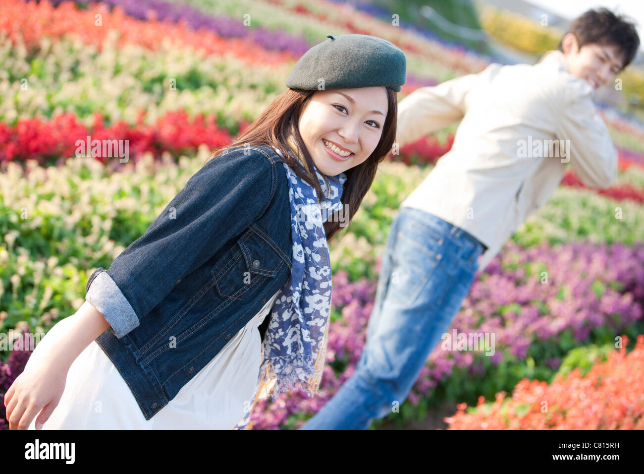 Young Couple in Flower Field Stock Photo - Alamy