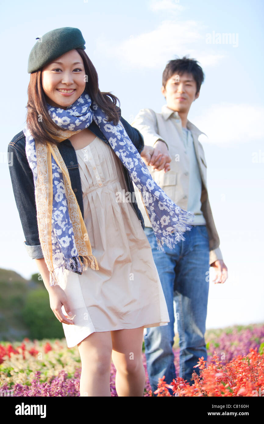 Young Couple in Flower Field Stock Photo - Alamy