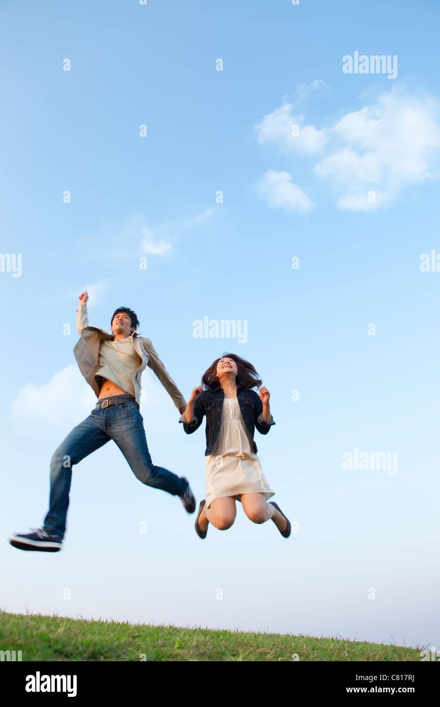 Young Couple Jumping Stock Photo - Alamy