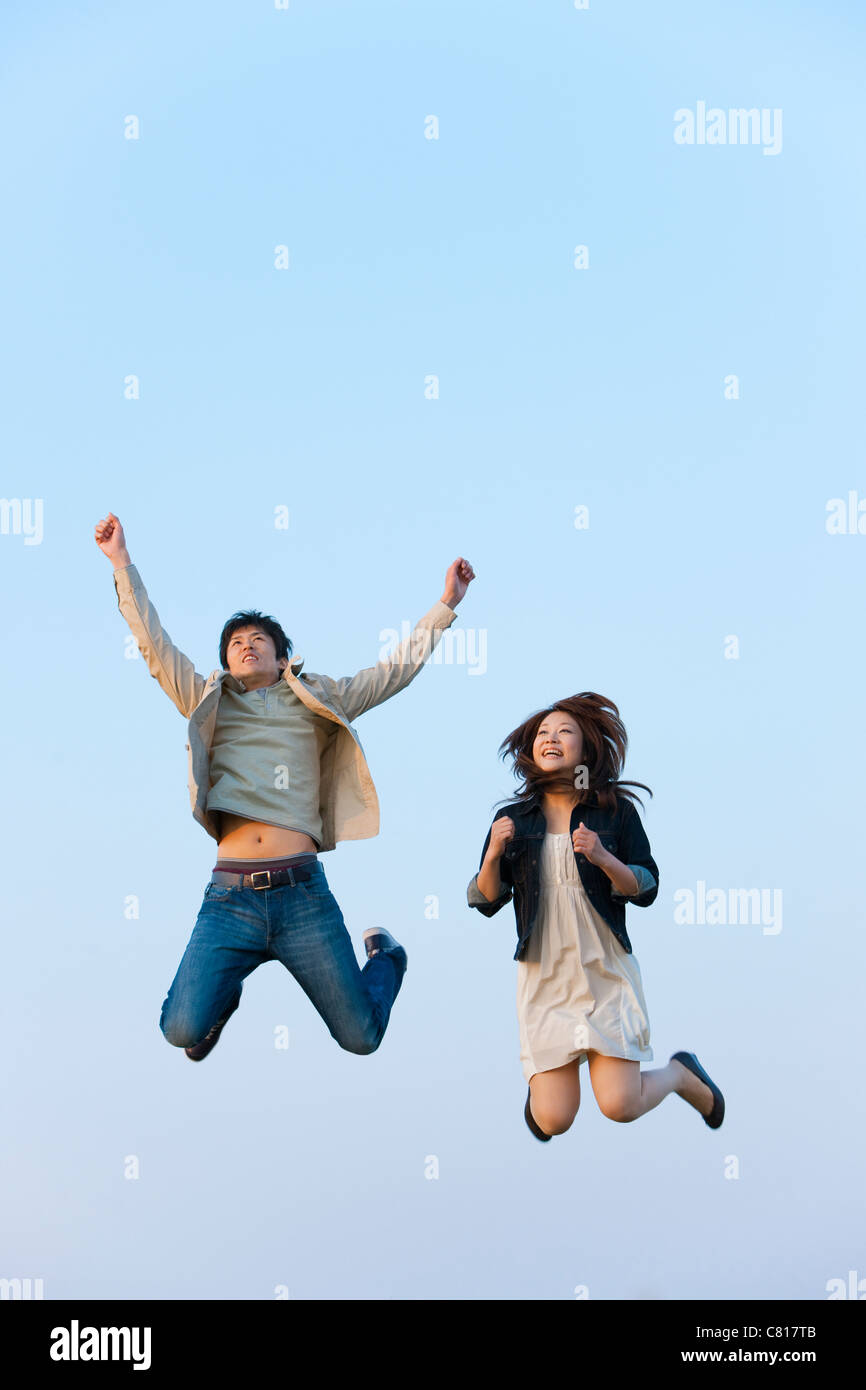Young Couple Jumping Stock Photo - Alamy