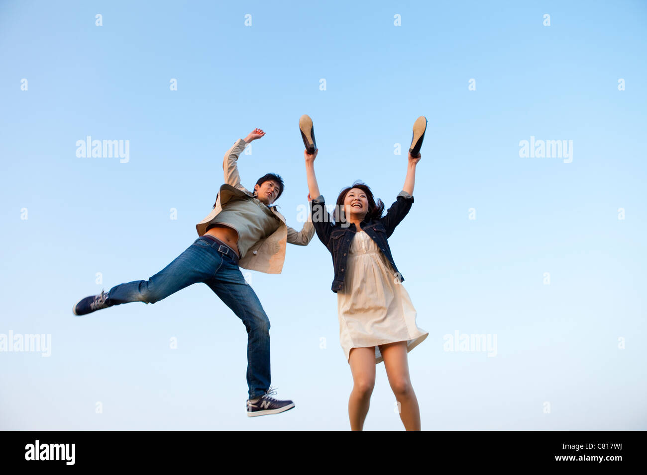 Young Couple Jumping Stock Photo - Alamy