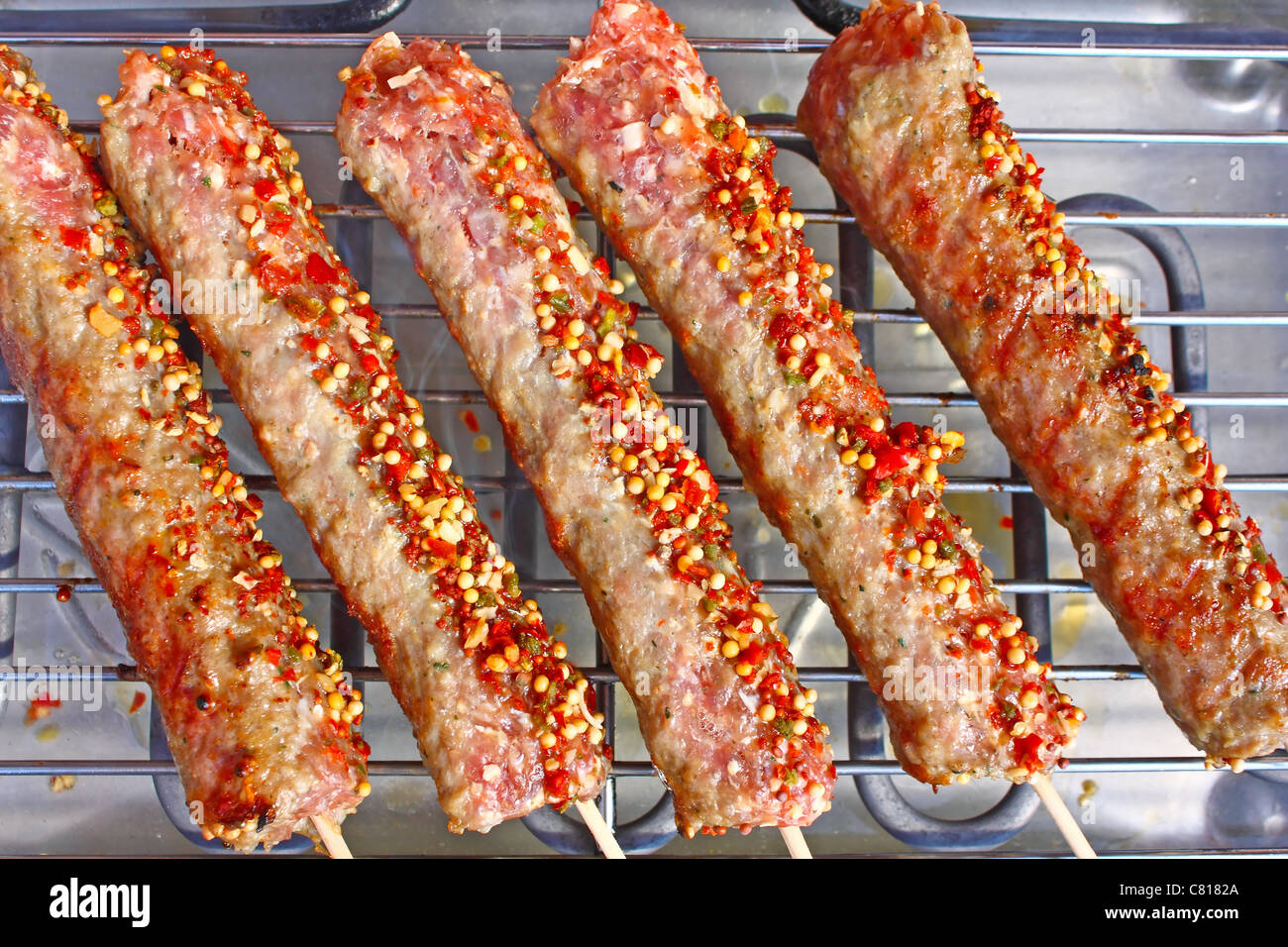 Preparing pork meat on the grill Stock Photo - Alamy