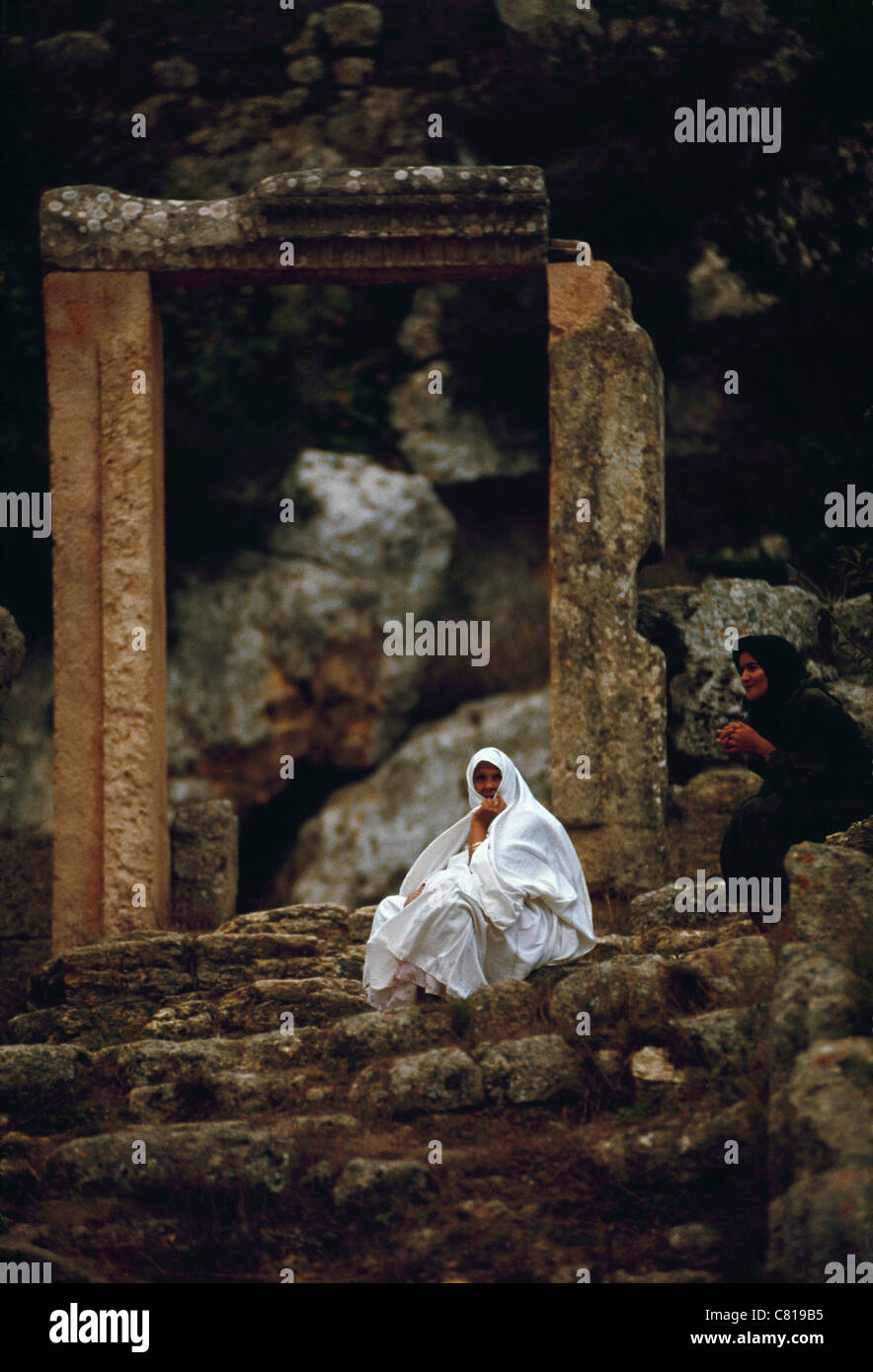Two Libyan women visiting the ancient graeco roman site at Shahhat, one ...