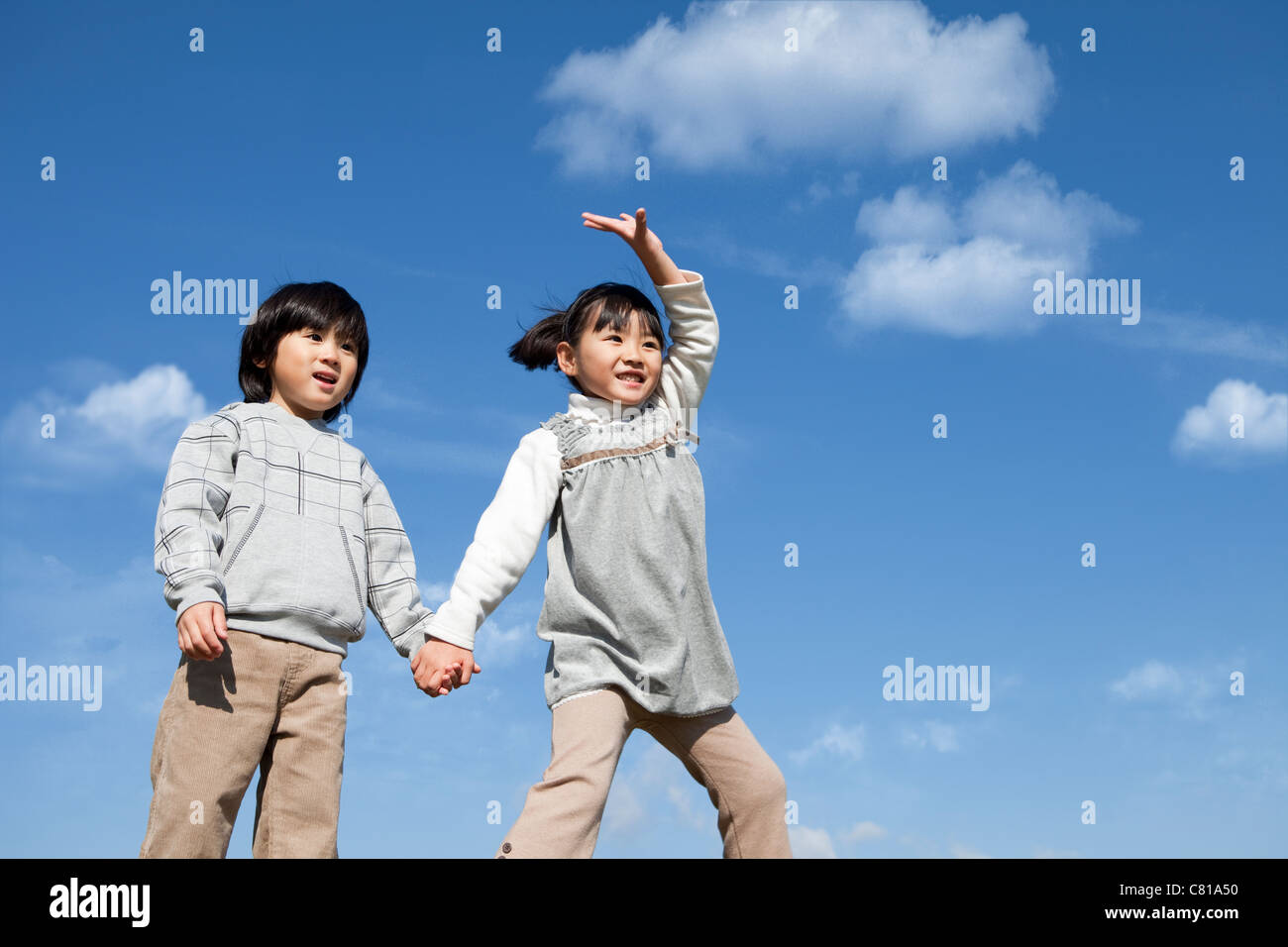 Boy and Girl Jumping Stock Photo - Alamy