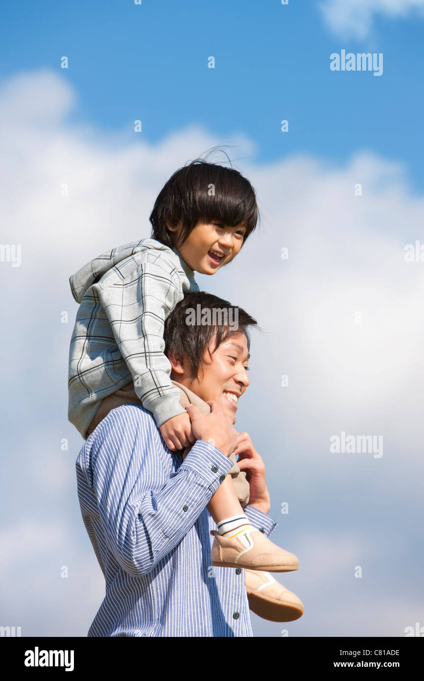 Father Carrying Boy on Shoulders Stock Photo - Alamy