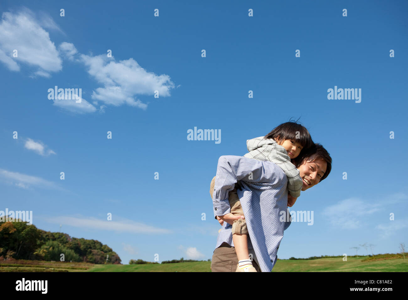 Father Carrying Boy on Back Stock Photo - Alamy