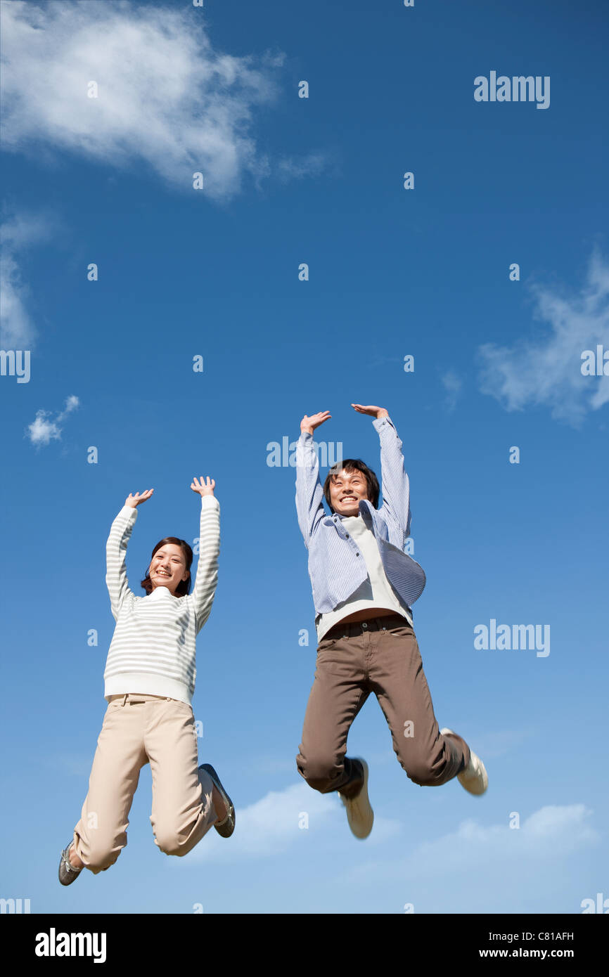 Young Couple Jumping in Mid Air Stock Photo - Alamy