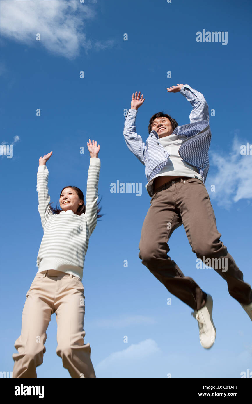 Young Couple Jumping in Mid Air Stock Photo - Alamy