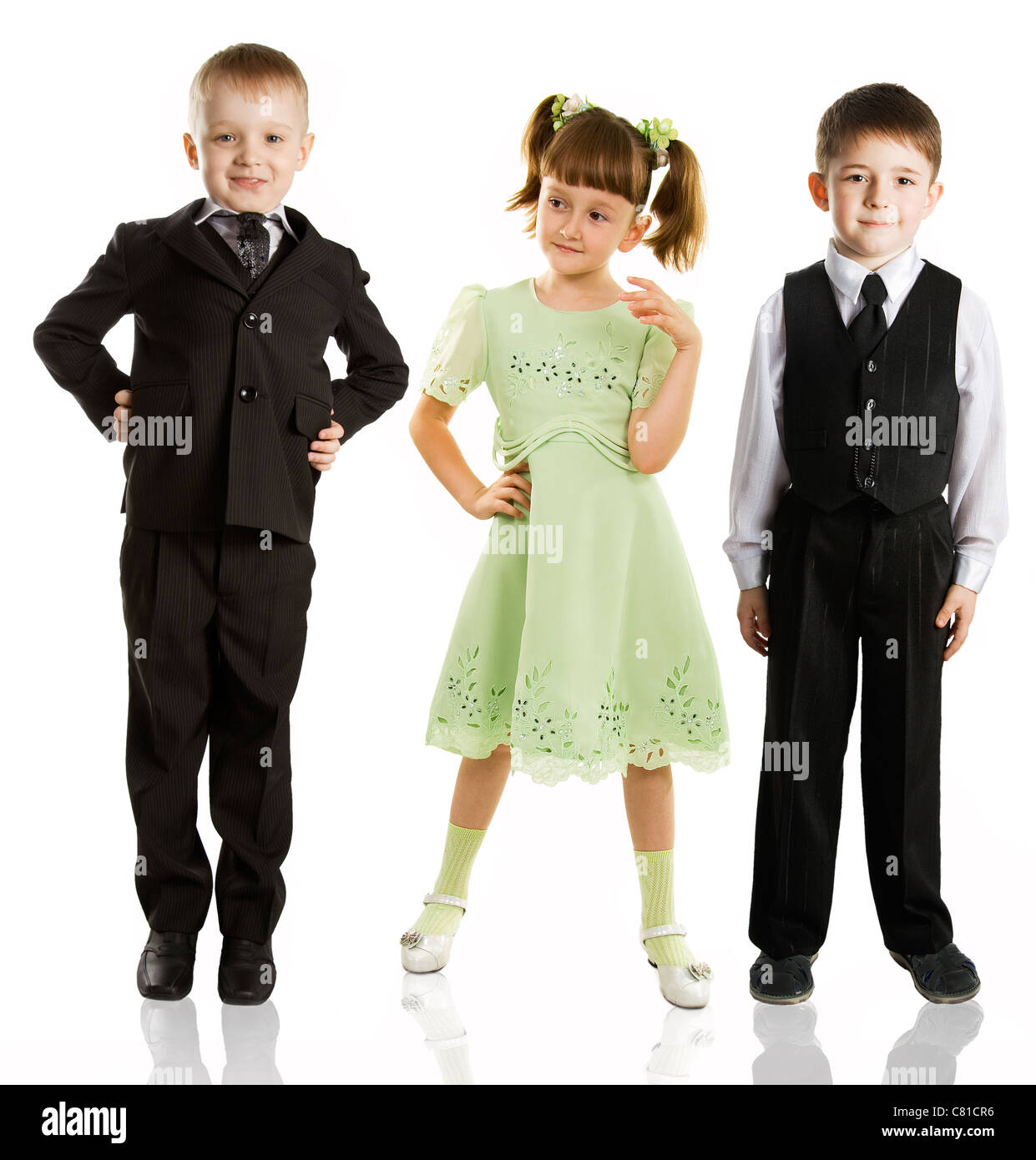3 fashionable children stand on a white background Stock Photo - Alamy