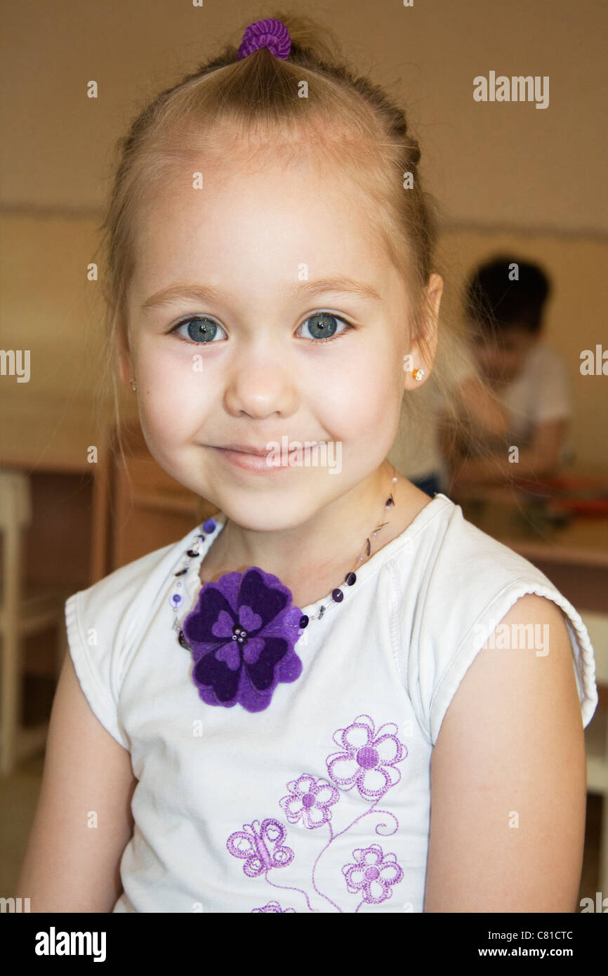 Modest, shy little girl in a kindergarten smille Stock Photo - Alamy