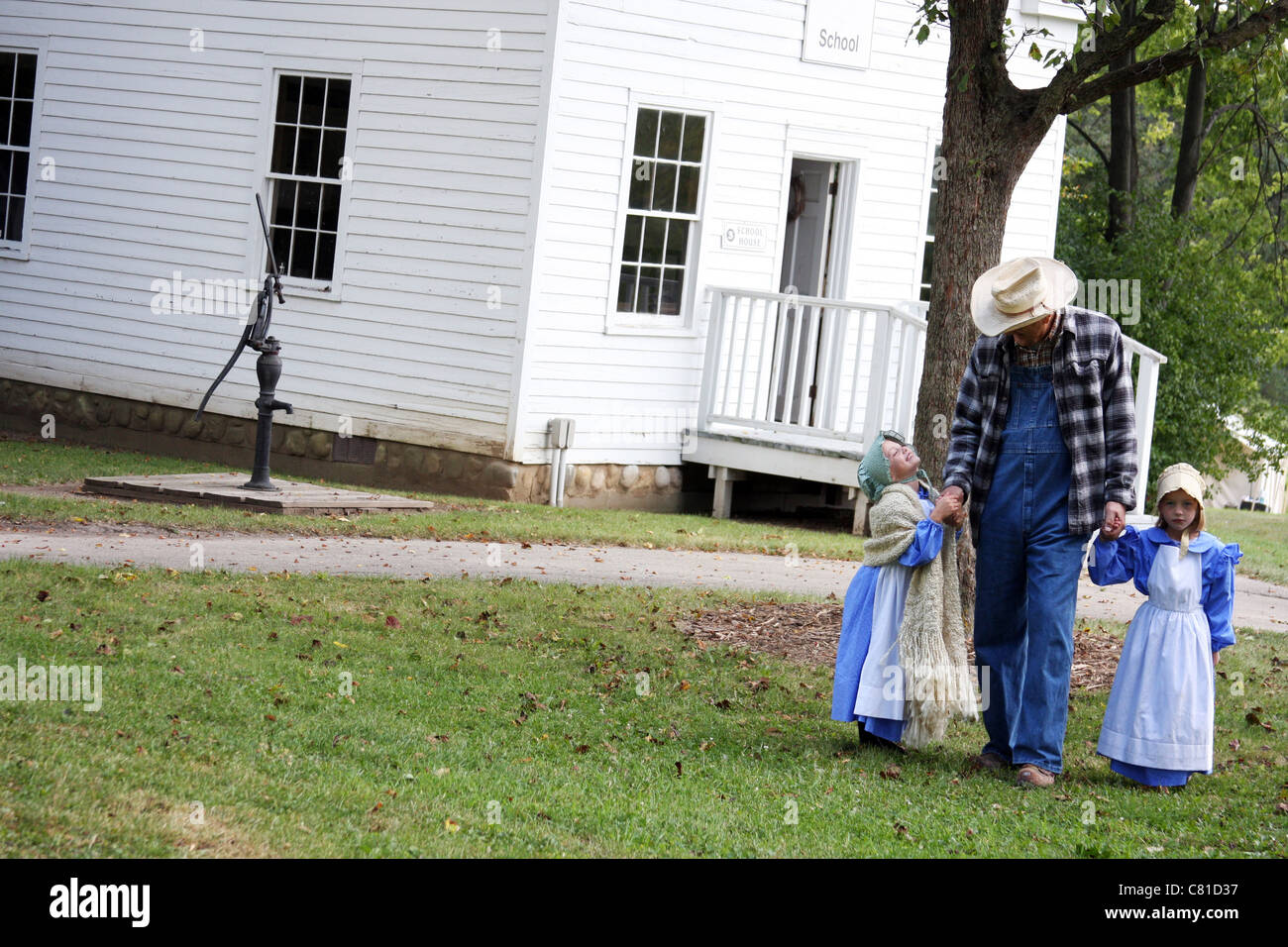 A male farmer and two country girls walking holding hands Stock Photo ...