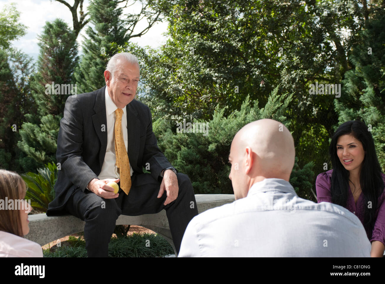 Hispanic business people talking together outdoors Stock Photo - Alamy