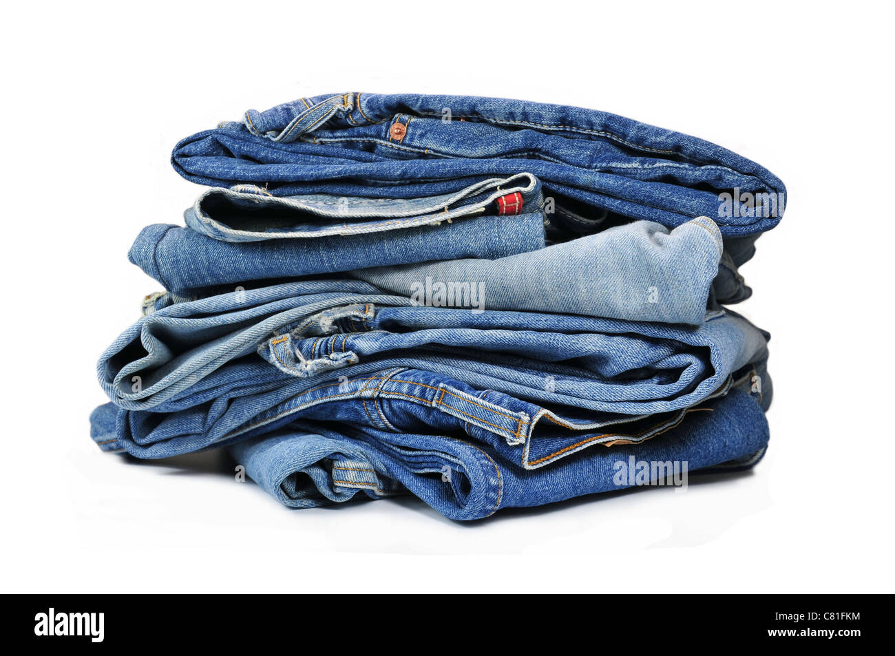Pile of blue denim jeans on white background Stock Photo - Alamy