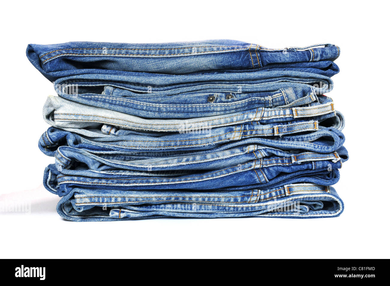 Pile of blue denim jeans on white background Stock Photo - Alamy