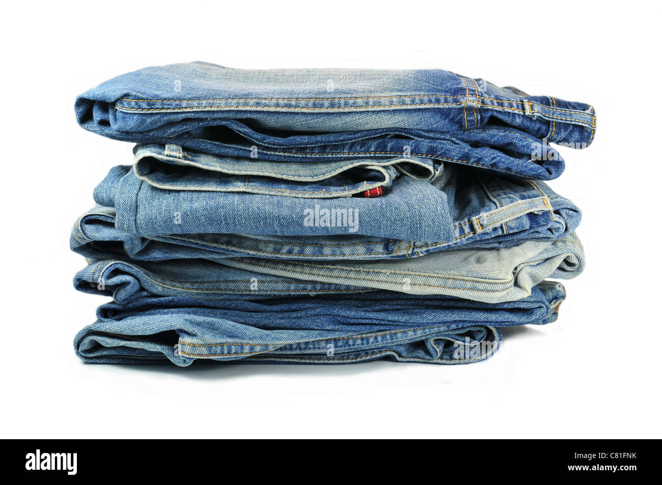 Pile of blue denim jeans isolated on white background Stock Photo - Alamy