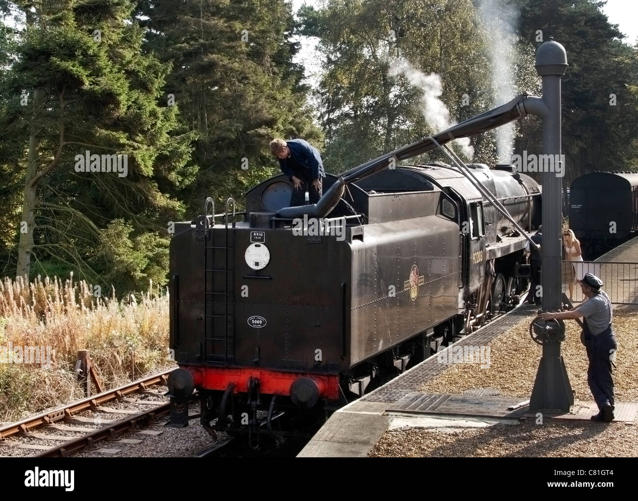 Steam engine being re-filled with water at Holt Station on the North ...