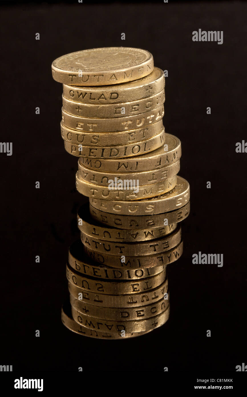 A pile of British pound coins on black Stock Photo - Alamy