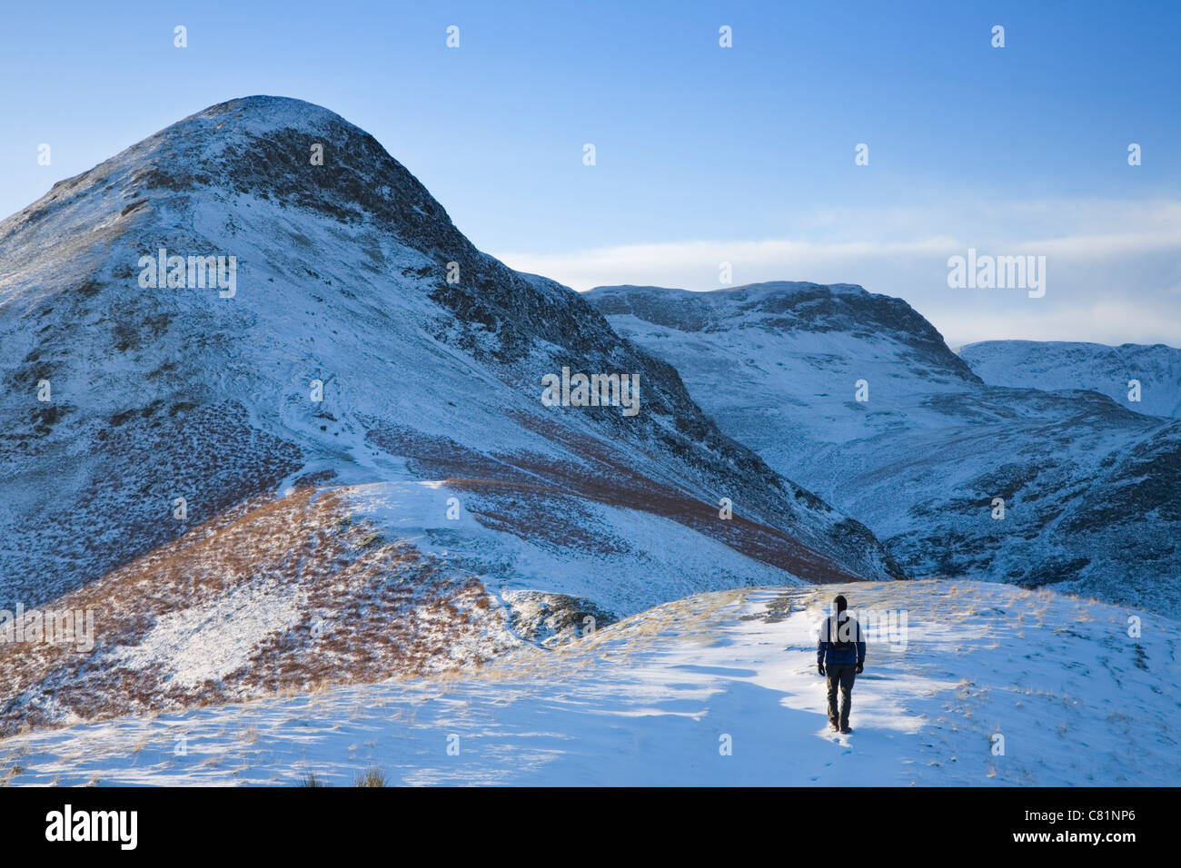 Walker approaching Cat Bells in winter. Lake District National Park ...