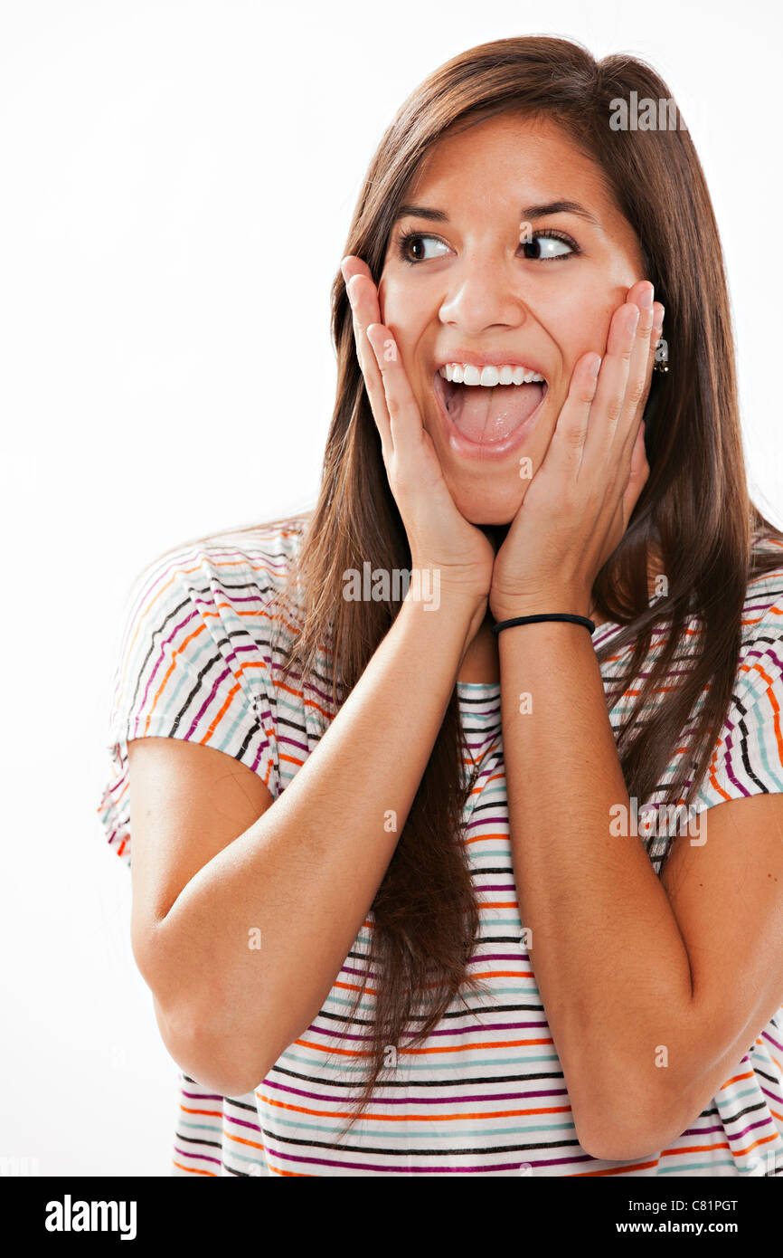 An attractive teenage female girl close excited on a white background ...