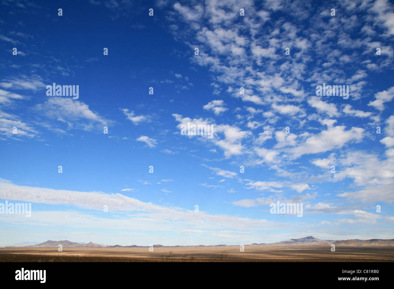 big sky country in the desert with clouds and empty plains leading to ...