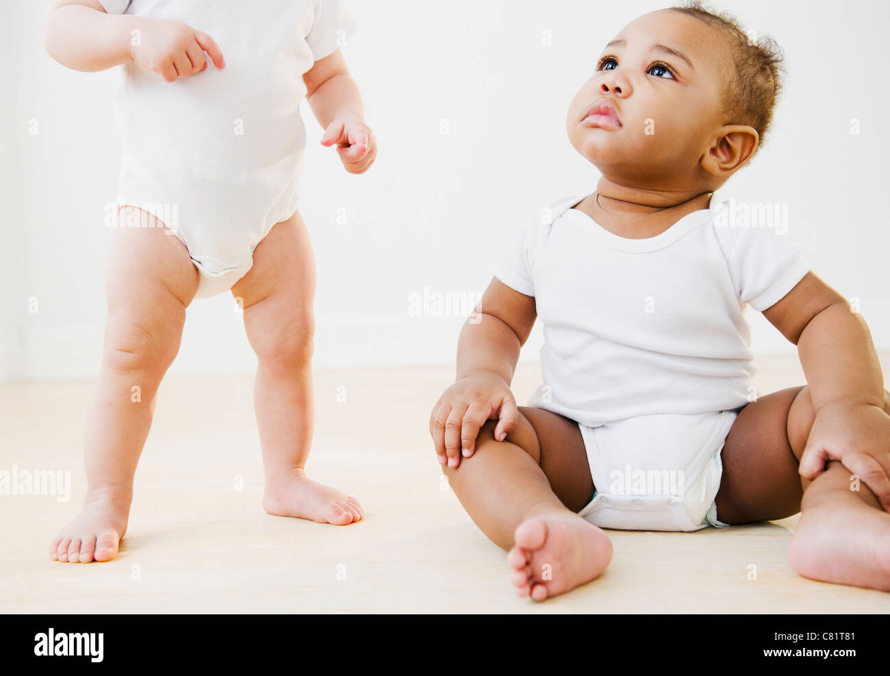 Babies playing together Stock Photo - Alamy