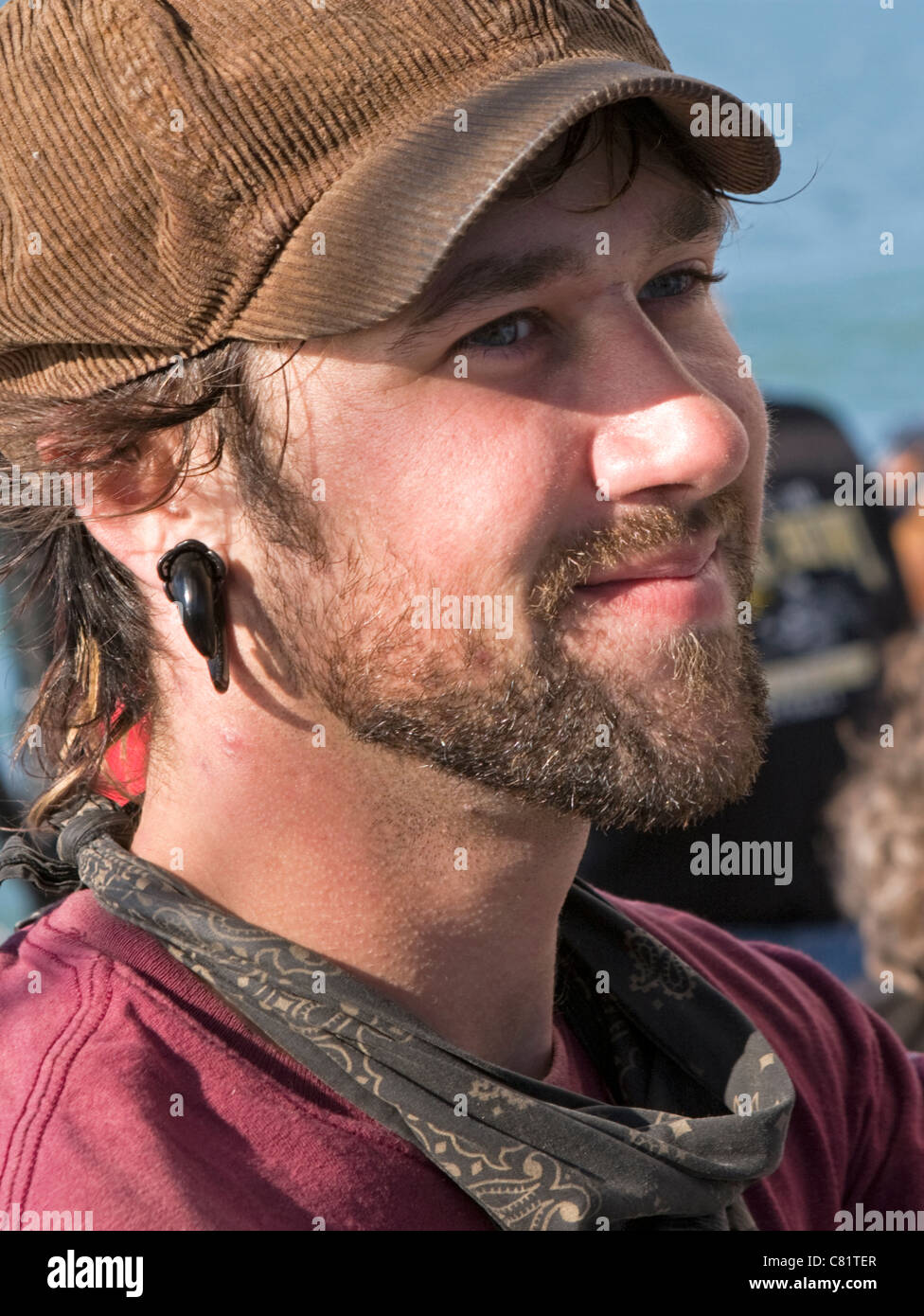 A crew member of the S/V Denis Sullivan sports a kerchief, cap, and ...