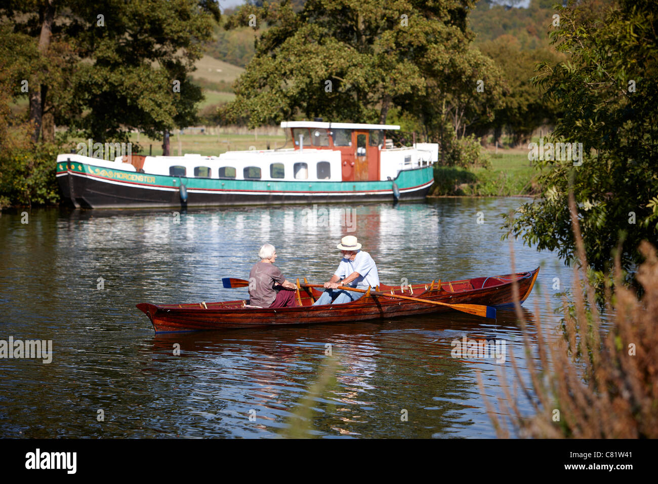 A man and a woman rowing on the River Thames near to Pangbourne ...
