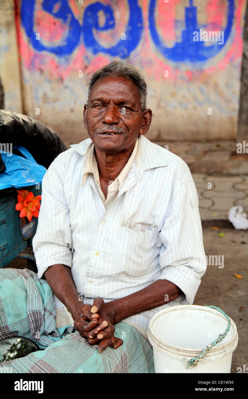 Portrait of old Indian man who lives on the street; he is a leper with ...