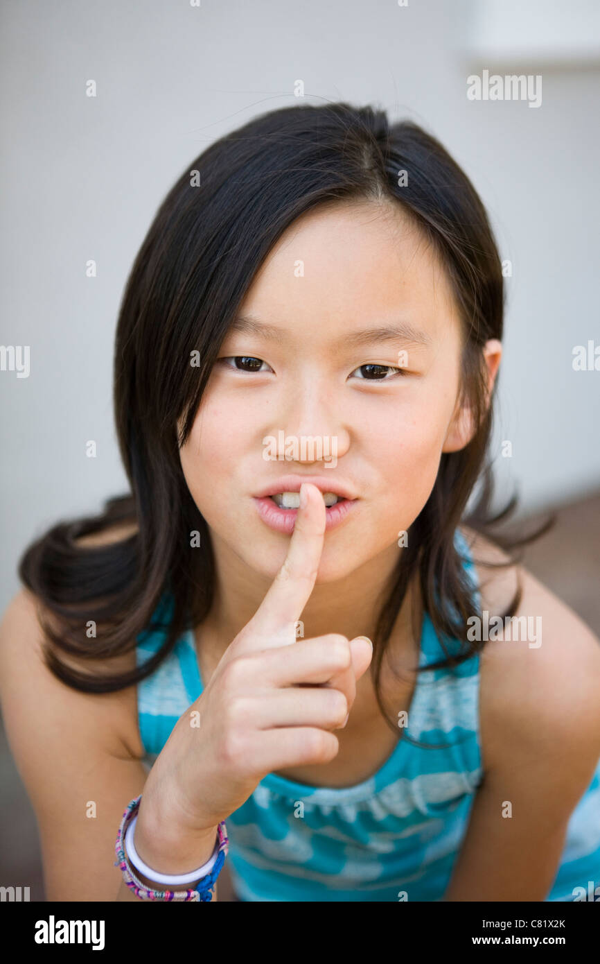 Chinese girl making shhh gesture Stock Photo - Alamy