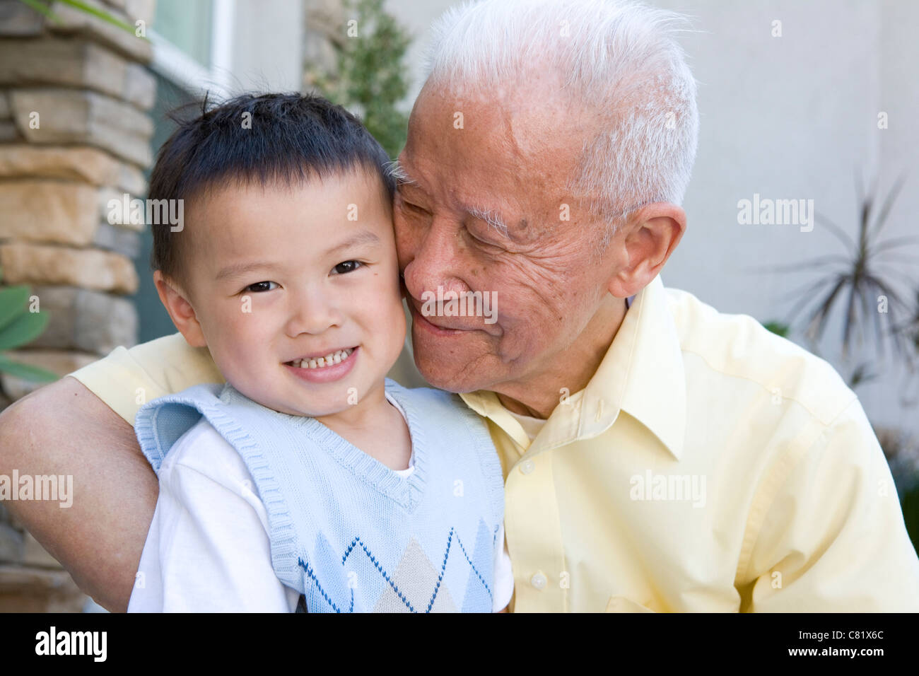 Chinese grandfather hugging grandson Stock Photo - Alamy