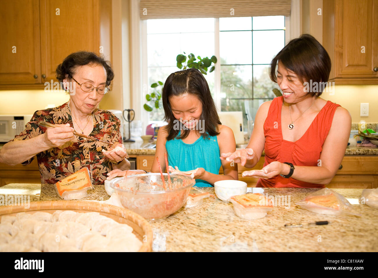 Multi-generation Chinese family cooking together Stock Photo - Alamy