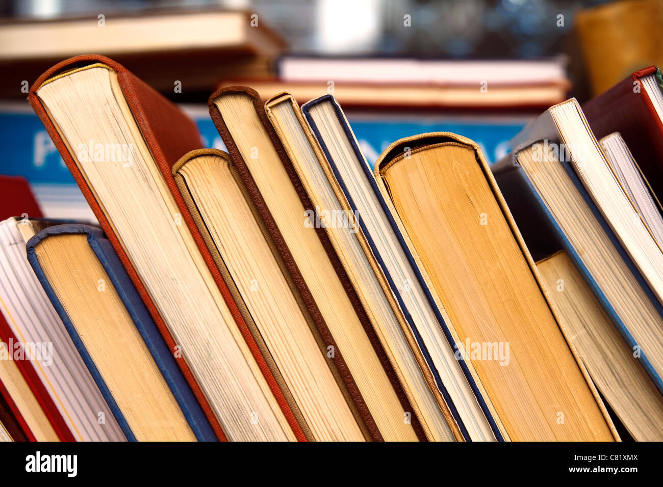 Old books leaning against each other for sale Stock Photo - Alamy