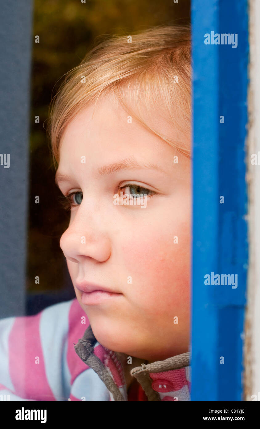 Sad girl looking out window white hi-res stock photography and images ...