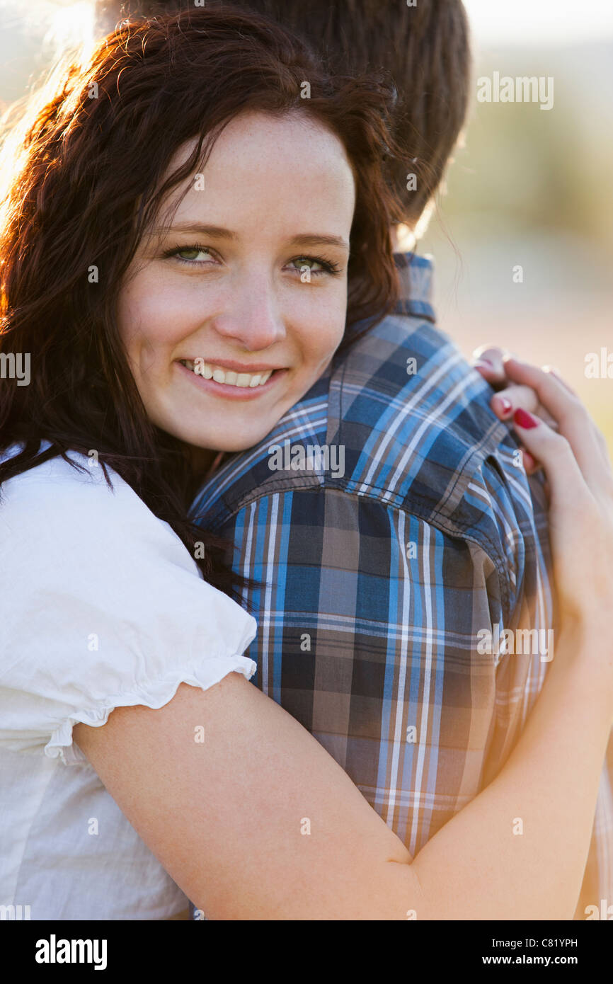 Caucasian couple hugging Stock Photo - Alamy