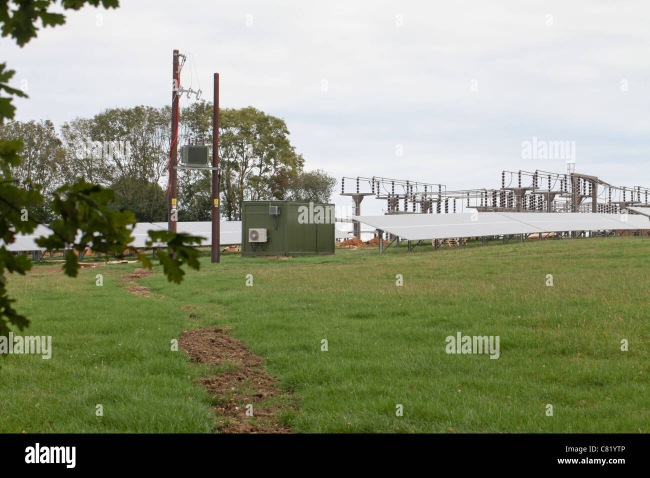 Solar panels and transformer in field Stock Photo - Alamy