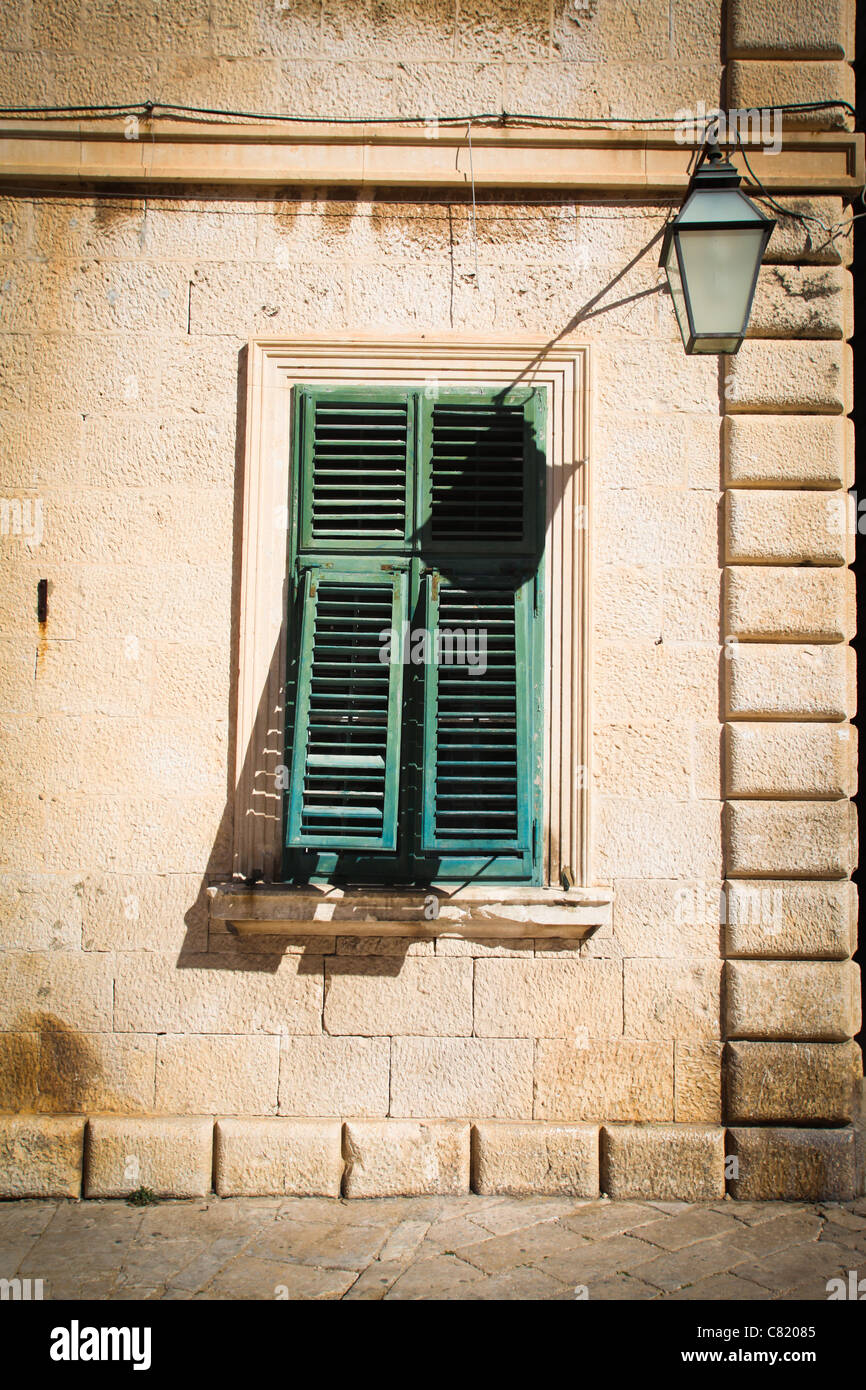 Old building wall with green shutters and street lamp - vintage style ...