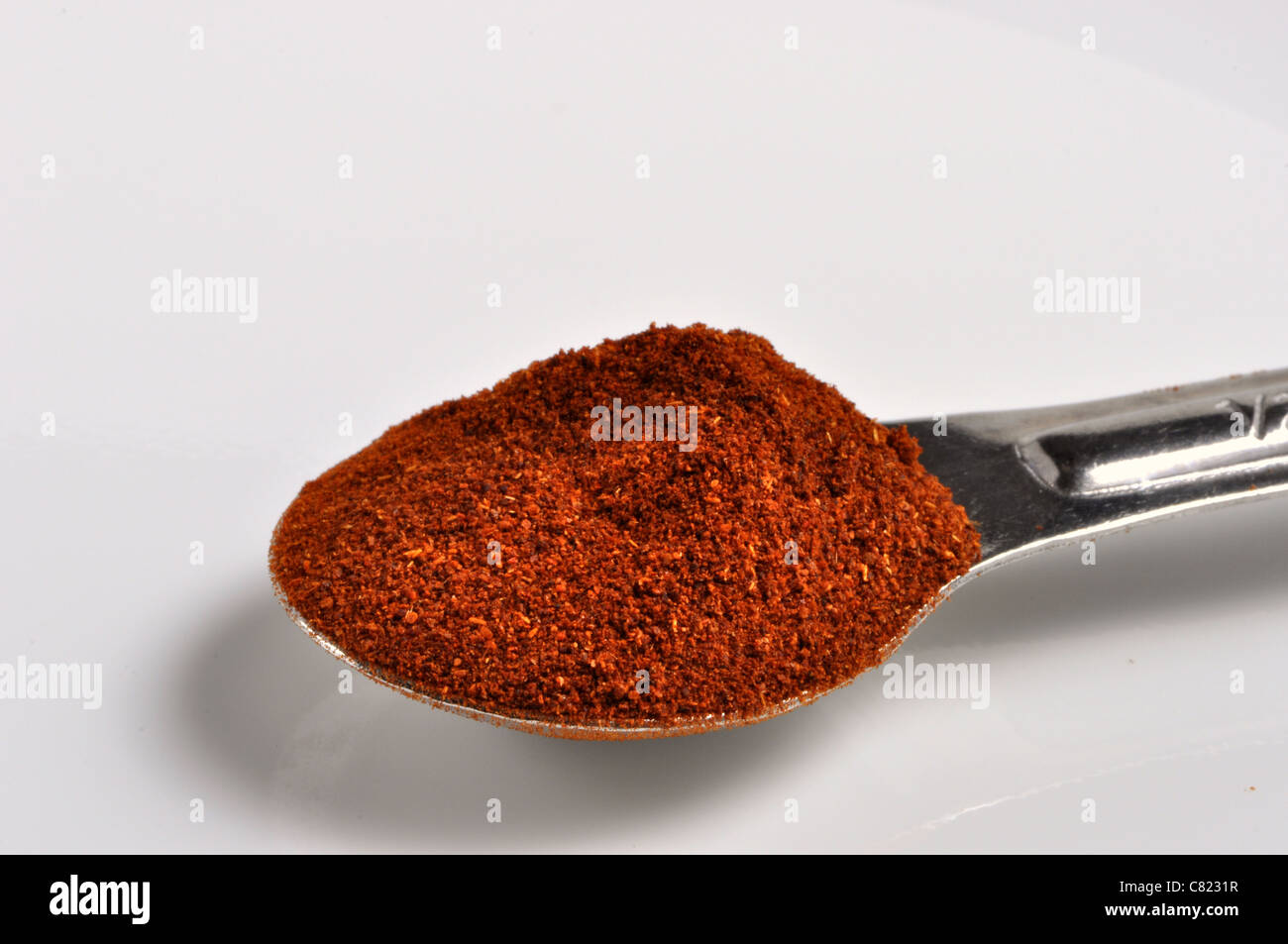 A spoonful of ground paprika on a plain white background Stock Photo ...