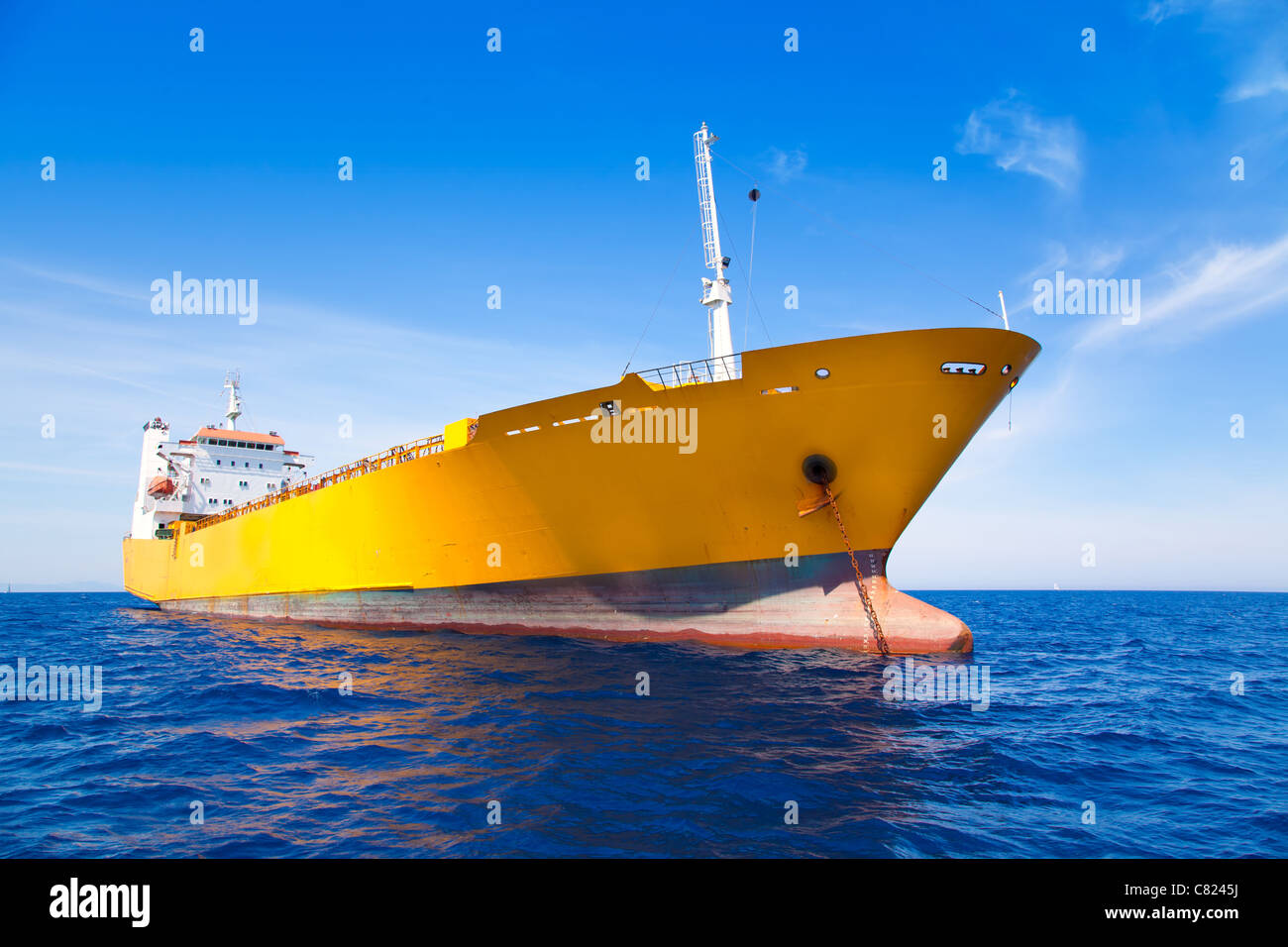 Anchor cargo yellow boat in blue sea under summer sky Stock Photo - Alamy