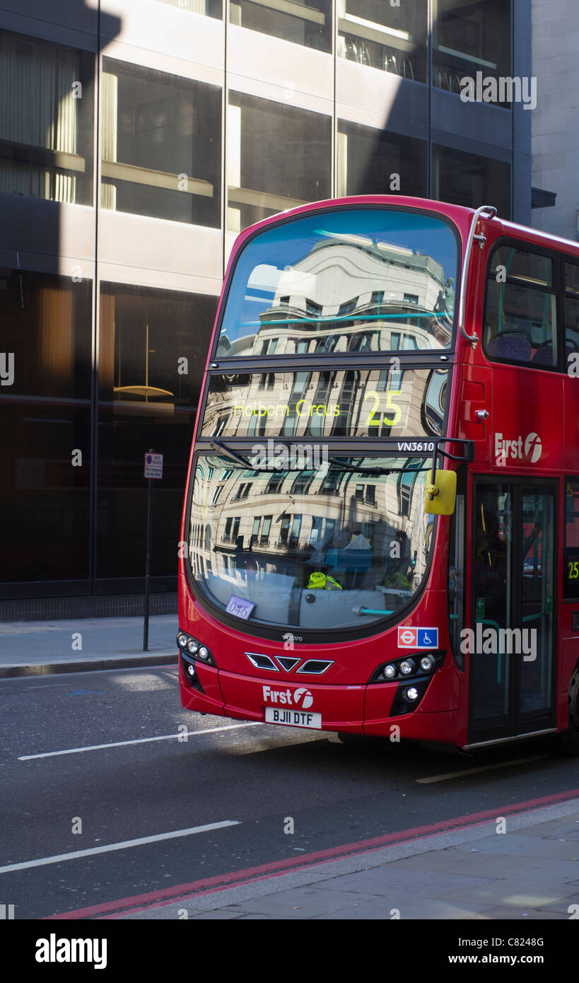 London bus in The City with architectural reflection on windscreen ...