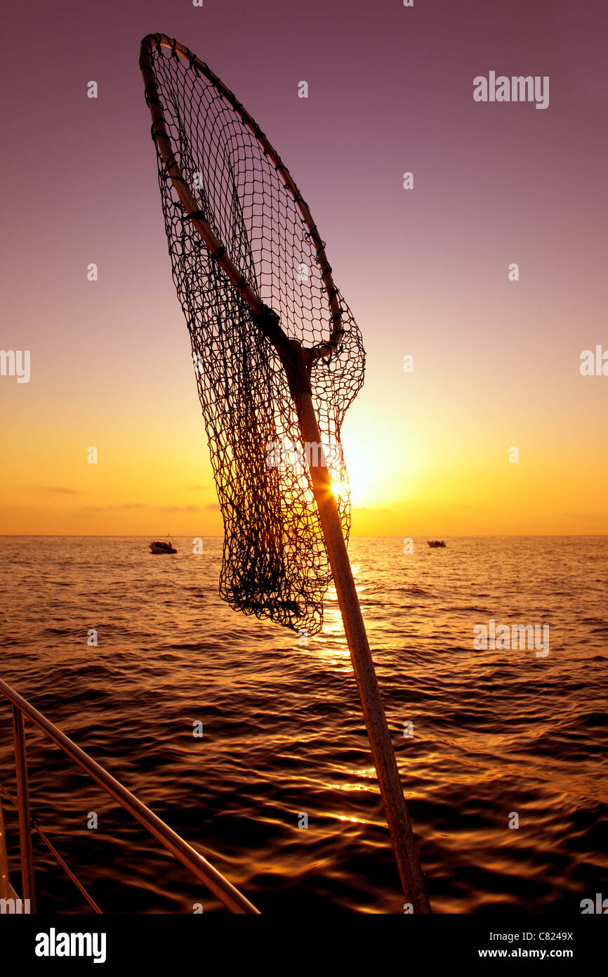dip net in boat fishing on sunrise water horizon Stock Photo - Alamy