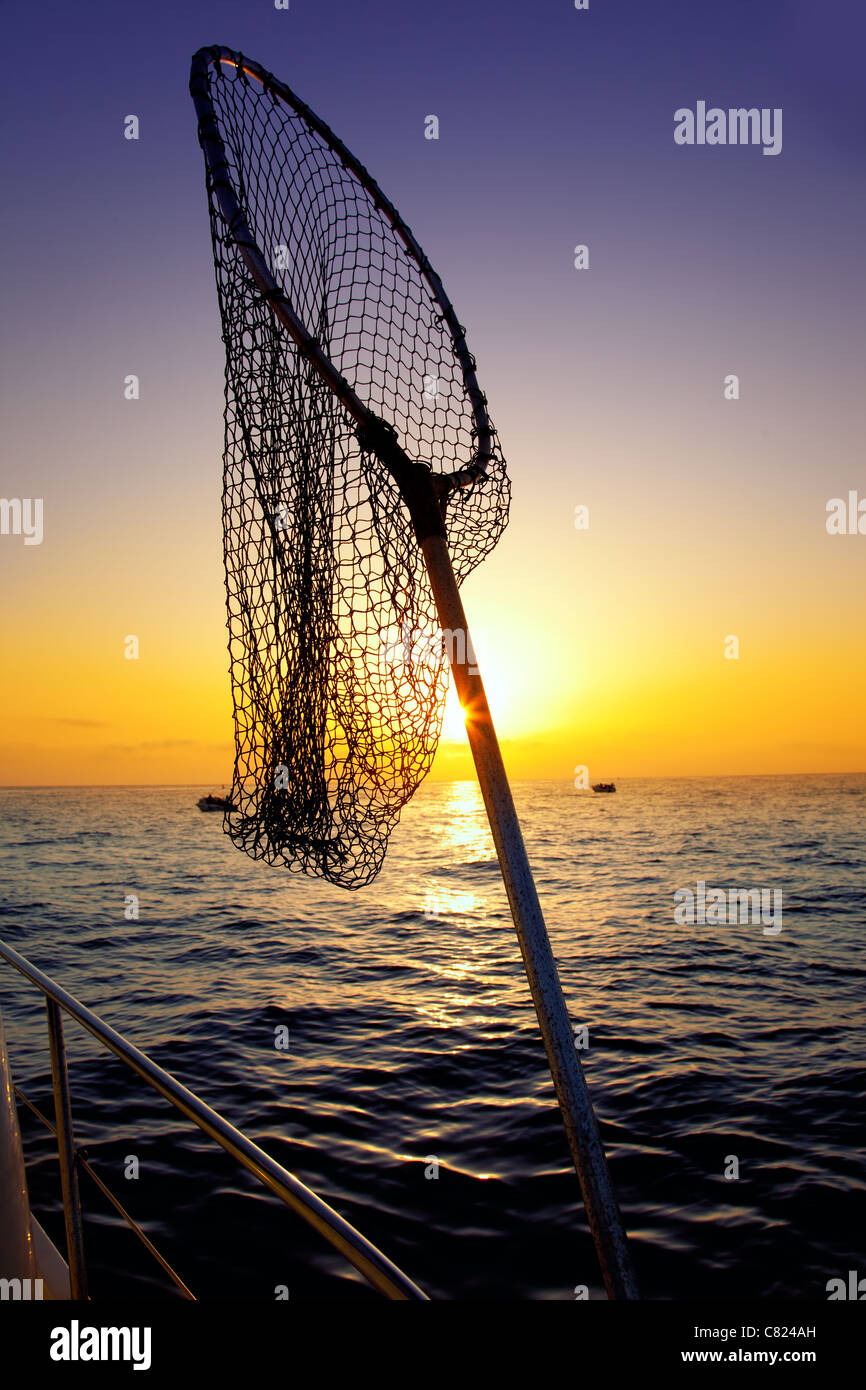 dip net in boat fishing on sunrise water horizon Stock Photo - Alamy
