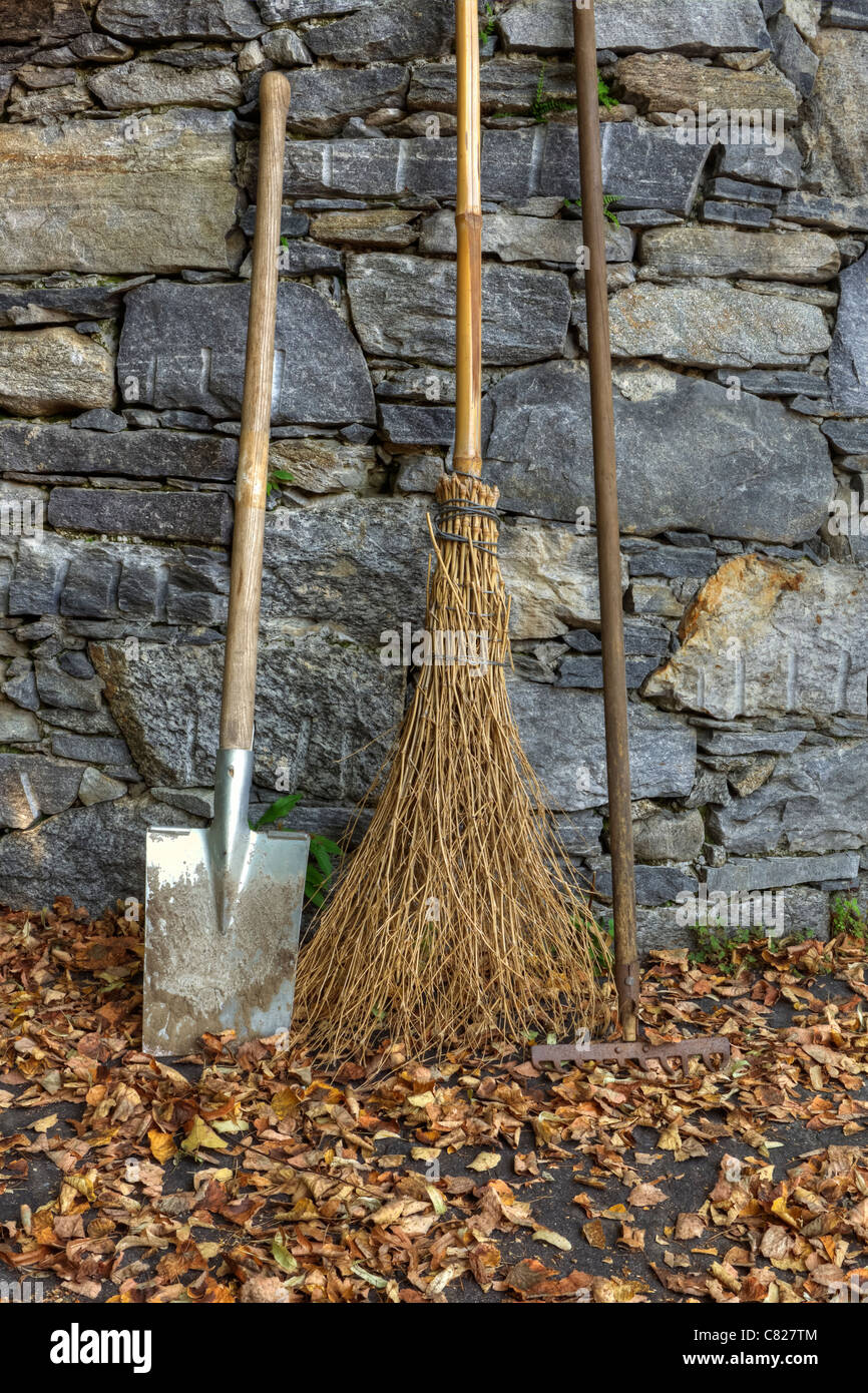 Spades, brooms and rakes for autumn gardening Stock Photo - Alamy