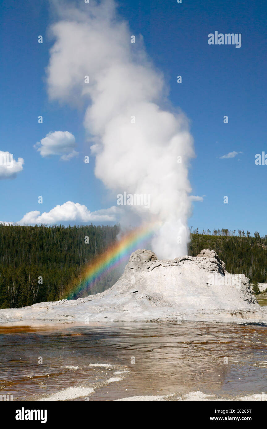 Castle Geyser erupting and rainbow in Yellowstone National Park ...
