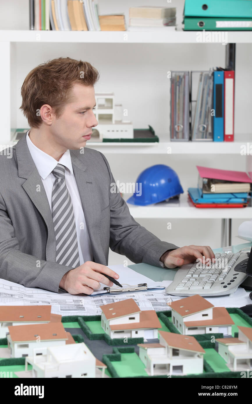 Young architect sitting at his desk Stock Photo - Alamy