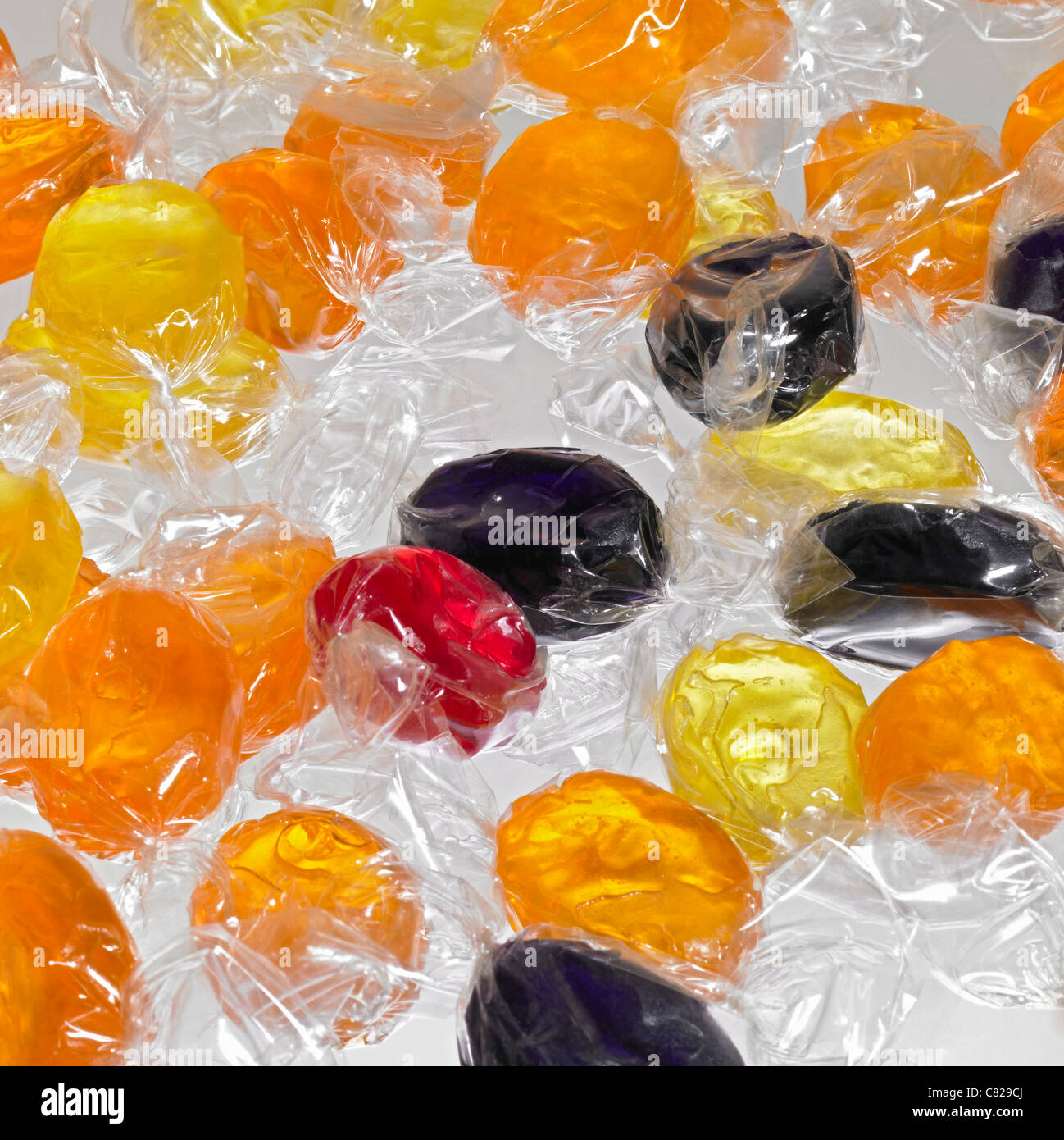 full frame background with wrapped colorful bonbons in light back Stock ...