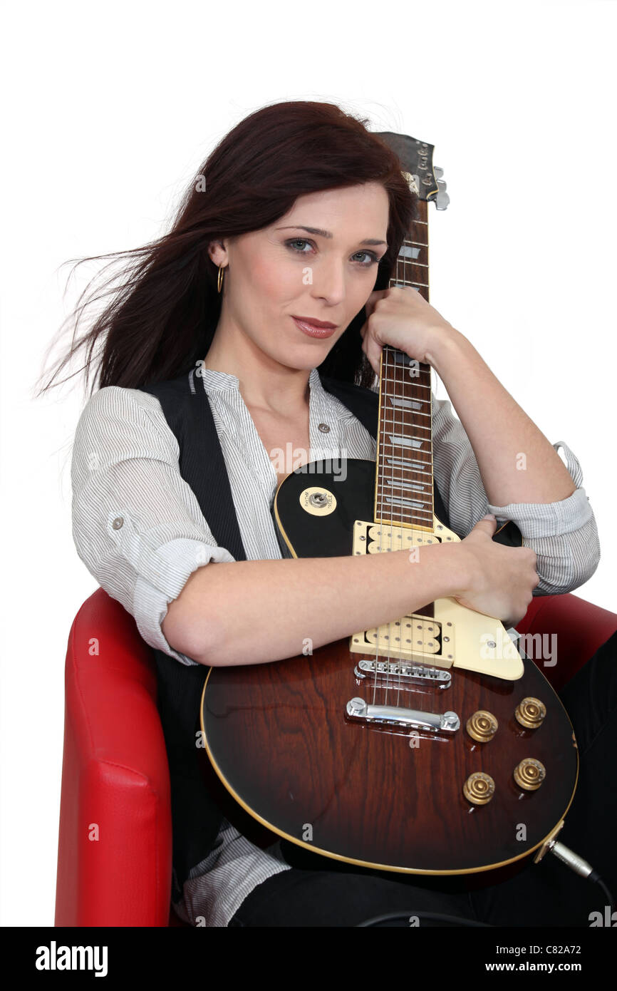 Attractive girl sitting with guitar Stock Photo - Alamy