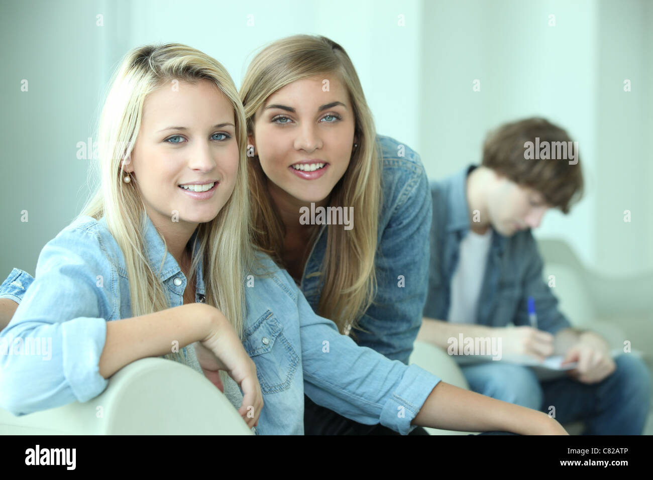 Two blond teenagers smiling at camera Stock Photo - Alamy