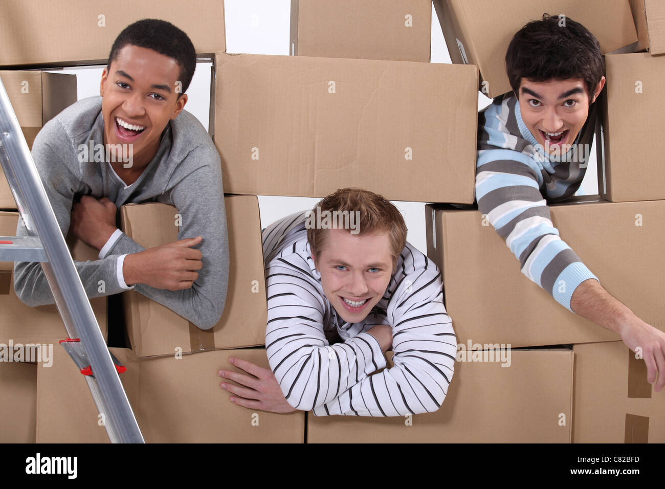 Three men moving house Stock Photo - Alamy
