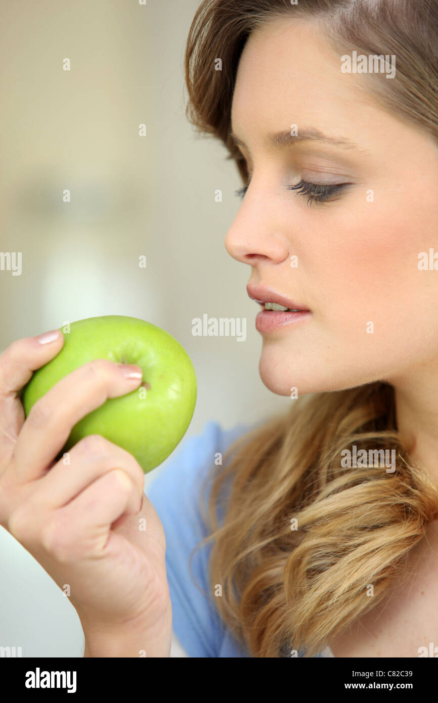 Woman eating an apple Stock Photo - Alamy
