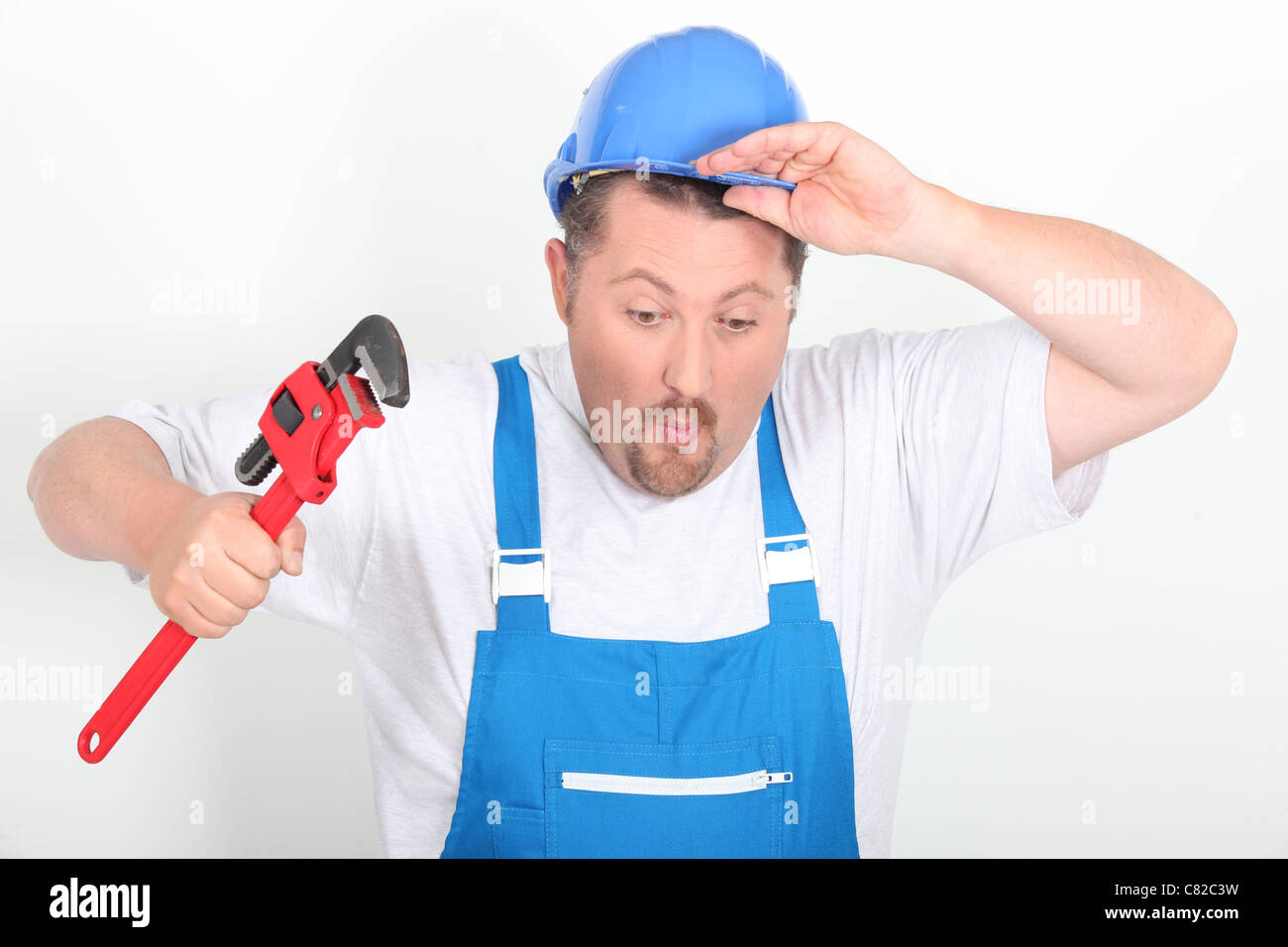 Comedy plumber with a wrench Stock Photo - Alamy